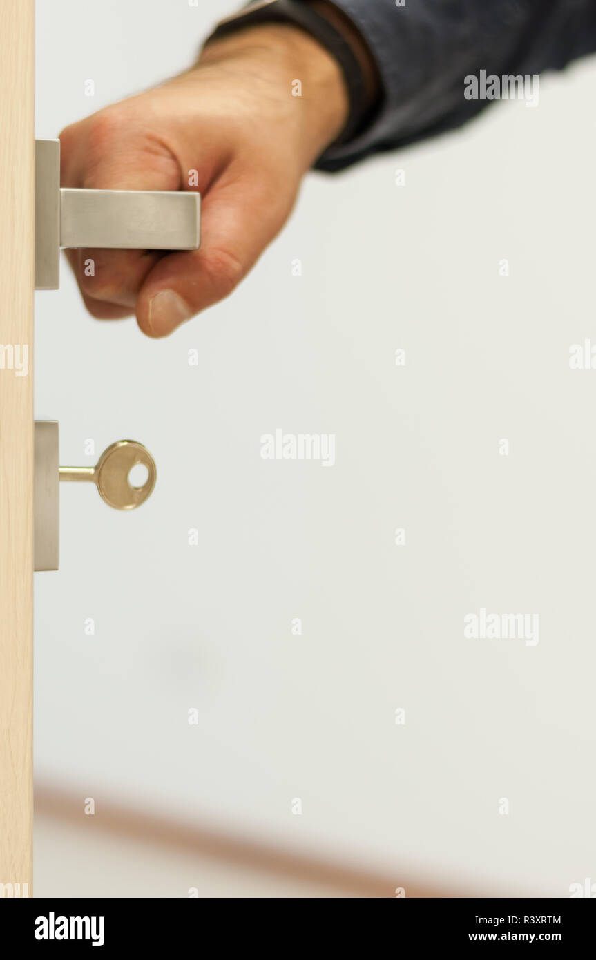 Door with an hand on the handle Stock Photo - Alamy