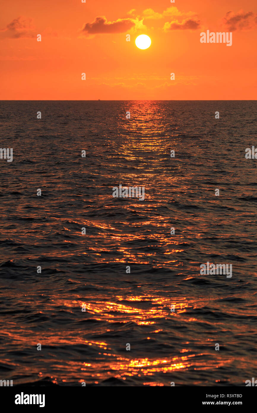 Sun setting on ocean off Maui, Hawaii, USA Stock Photo - Alamy