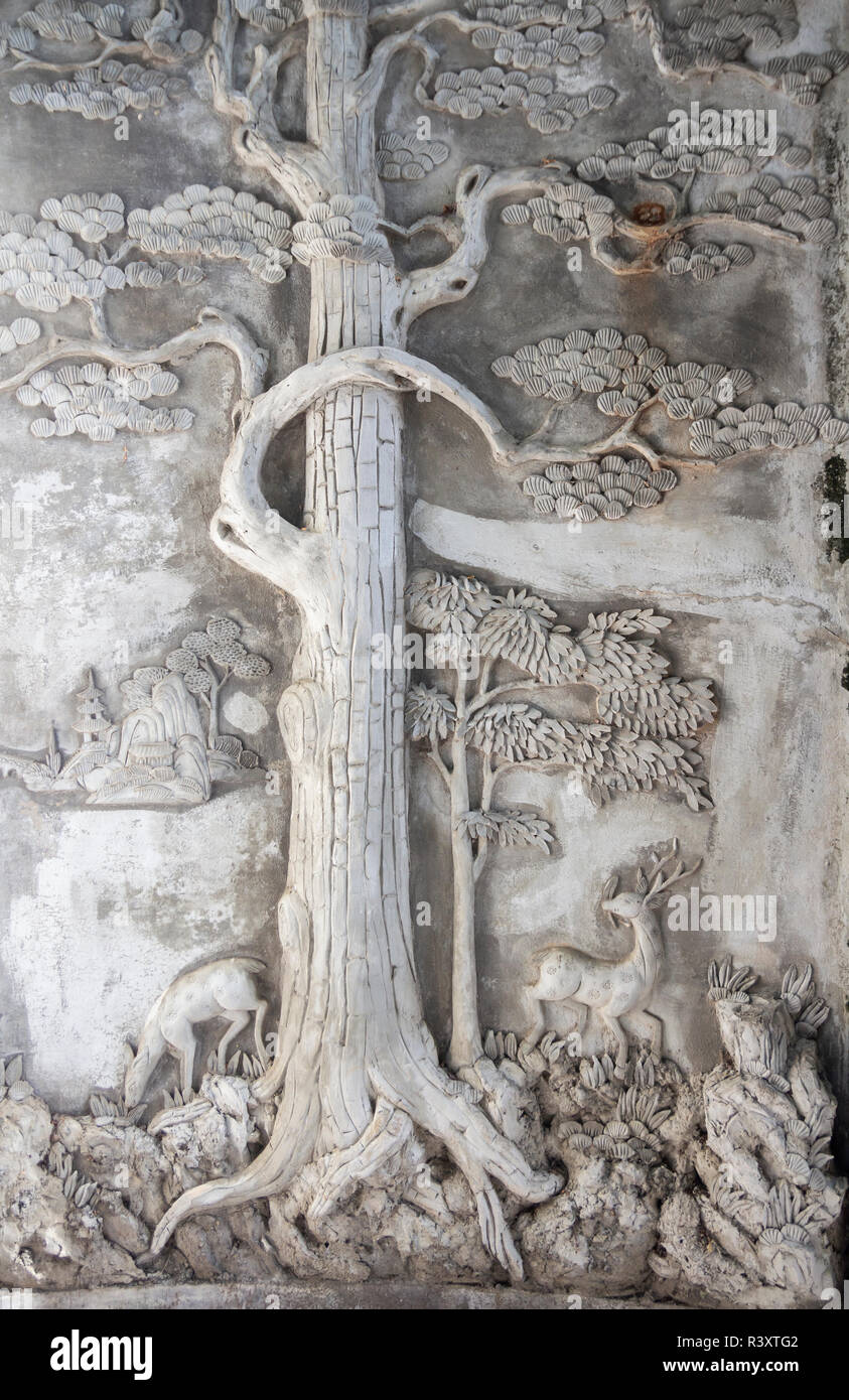 oriental tree basrelief on wall Stock Photo - Alamy
