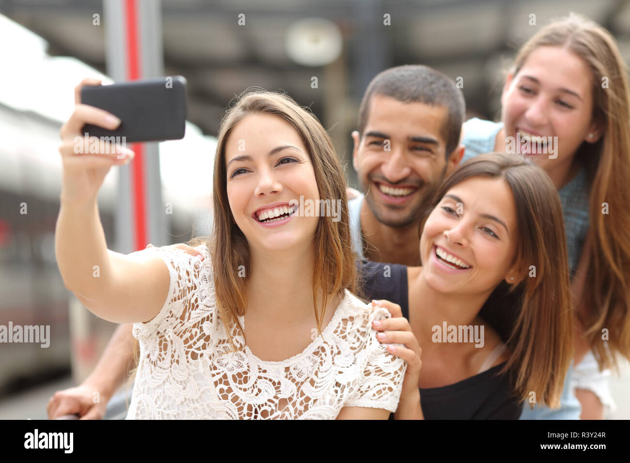 Group of four friends taking selfie with a smart phone Stock Photo - Alamy