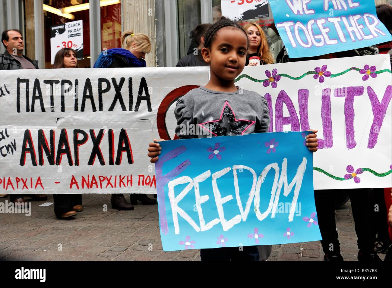 Athens, Greece. 24th Nov, 2018. A girl seen holding a placard as she ...