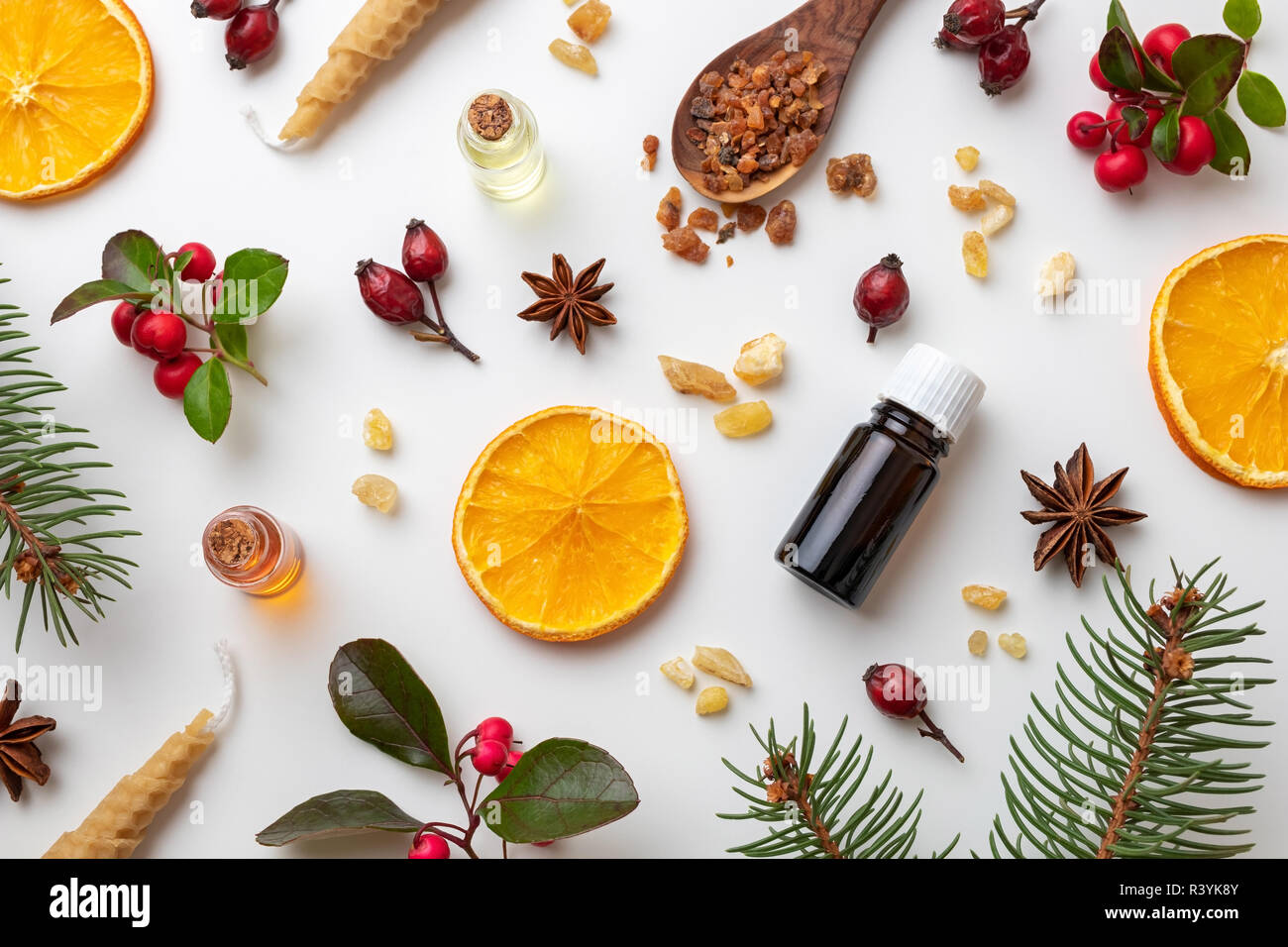 Bottles of essential oil on a white Christmas background with ...