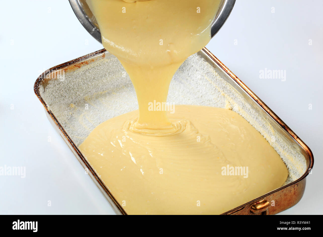 pouring batter into baking pan Stock Photo - Alamy
