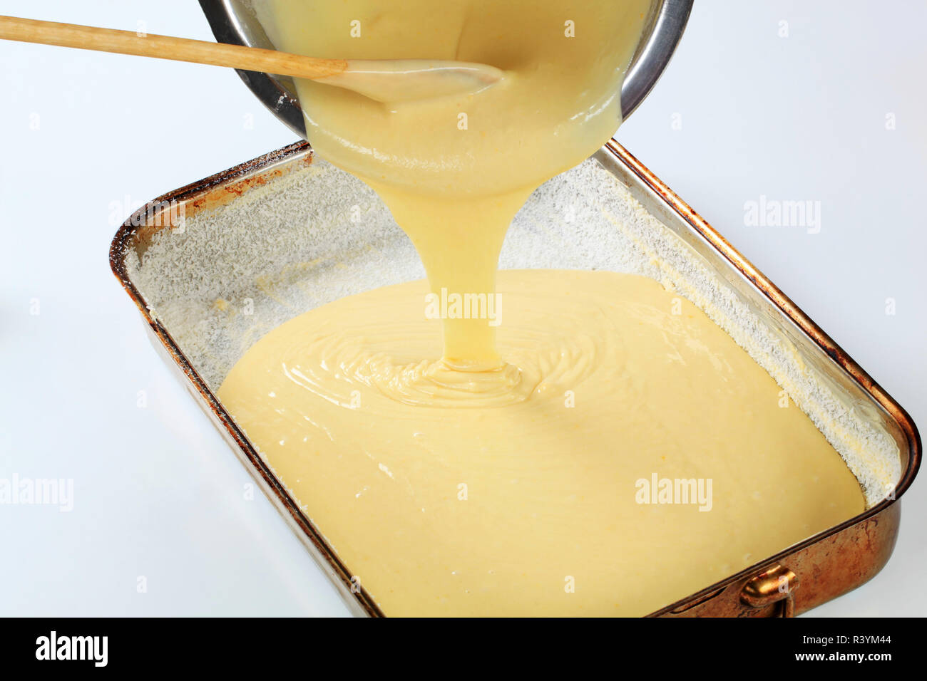 pouring batter into baking pan Stock Photo - Alamy