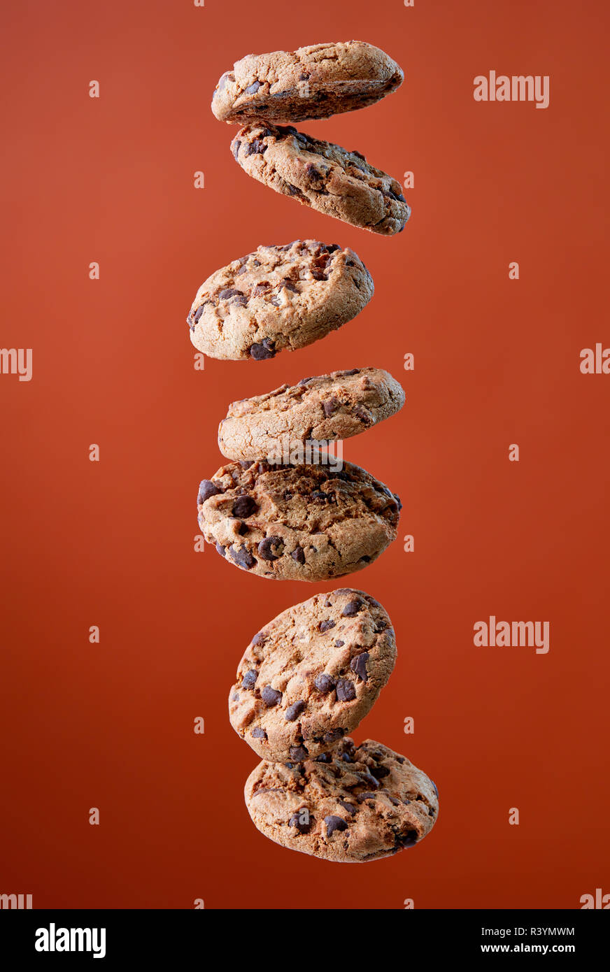 Chocolate chip cookies falling, brown background, food levitation Stock ...