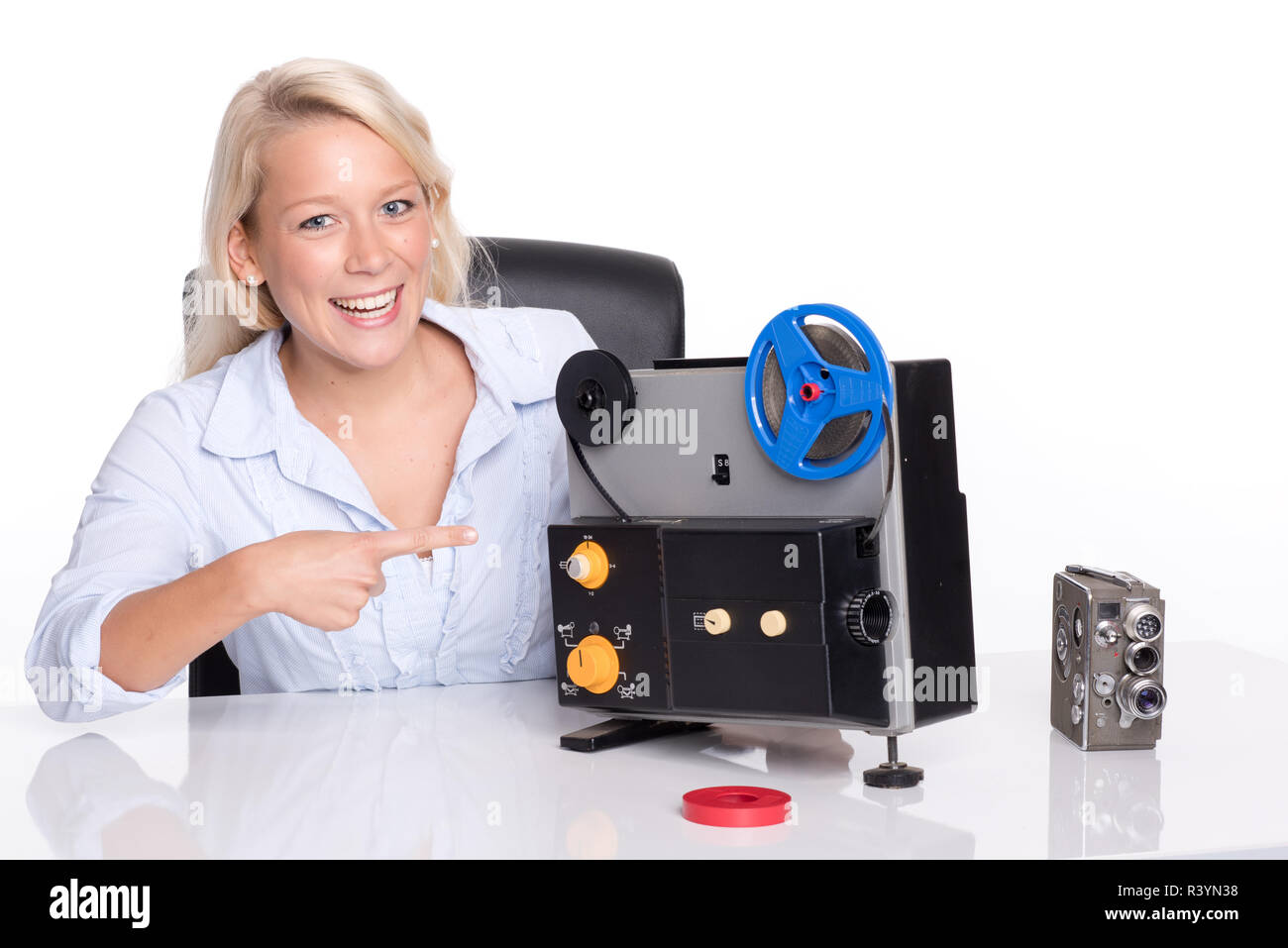 blonde woman pointing at an old movie projector Stock Photo - Alamy