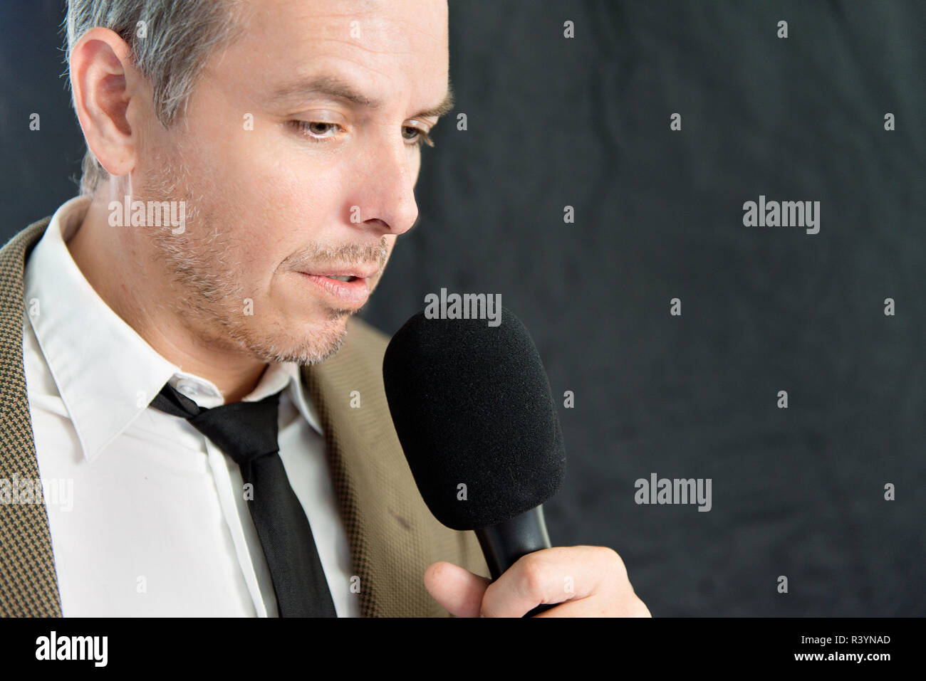 Serious Man Speaks Into Microphone Stock Photo - Alamy