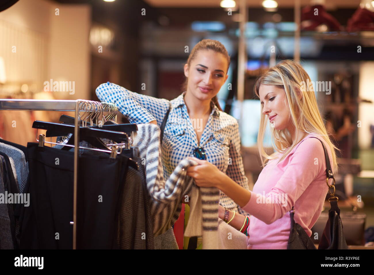 happy young girls in shopping mall Stock Photo - Alamy