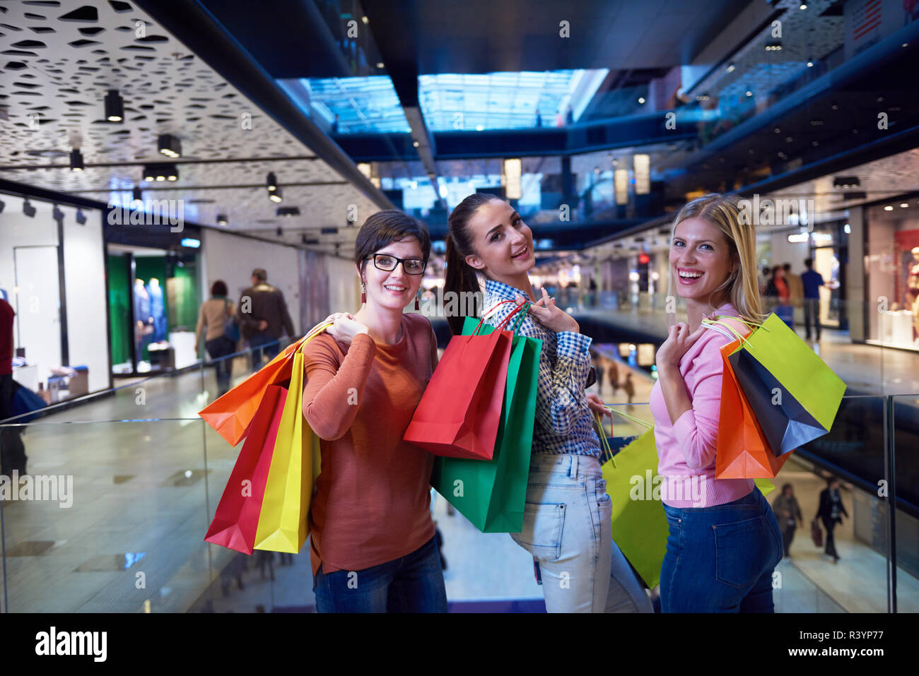 happy young girls in shopping mall Stock Photo - Alamy