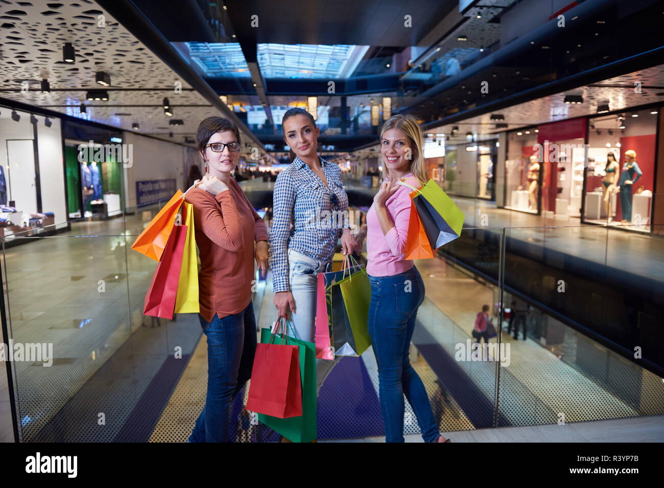 happy young girls in shopping mall Stock Photo - Alamy