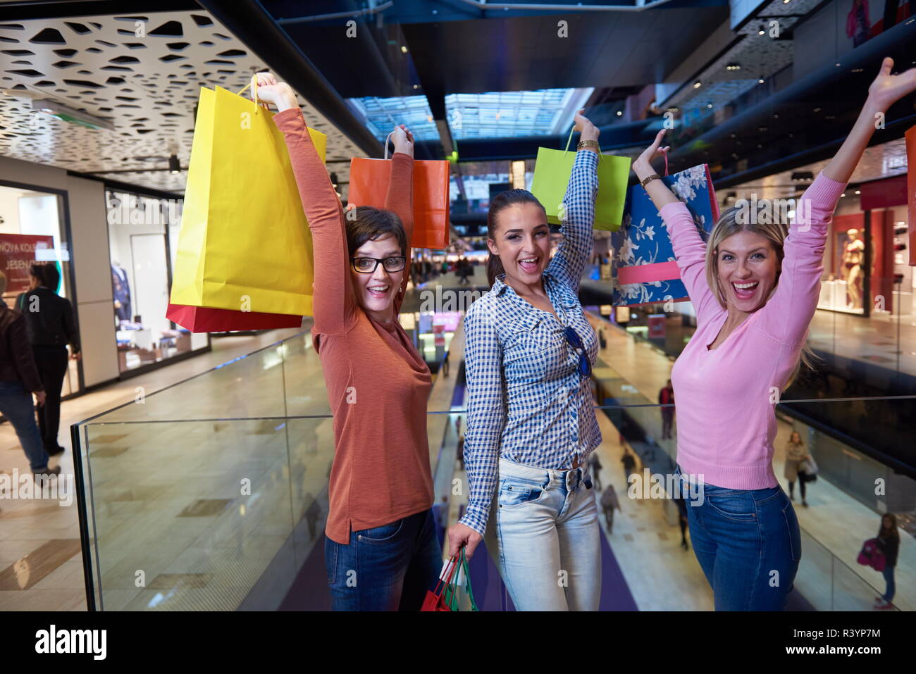 happy young girls in shopping mall Stock Photo - Alamy