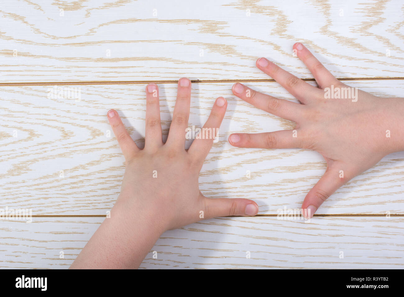 Hands making a gesture on a wooden background Stock Photo - Alamy