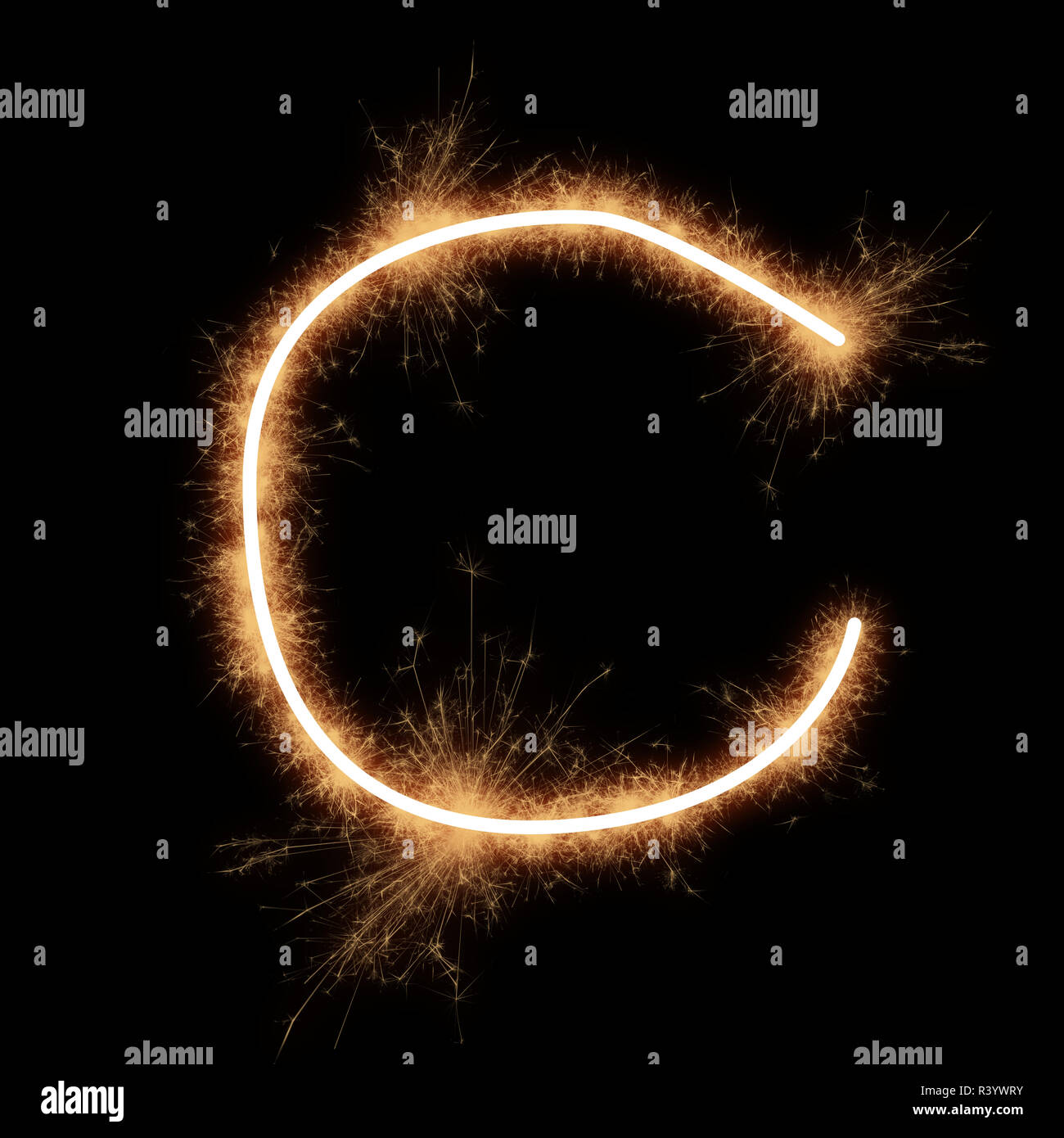 Letter C of alphabet written by squib sparks on a black background ...