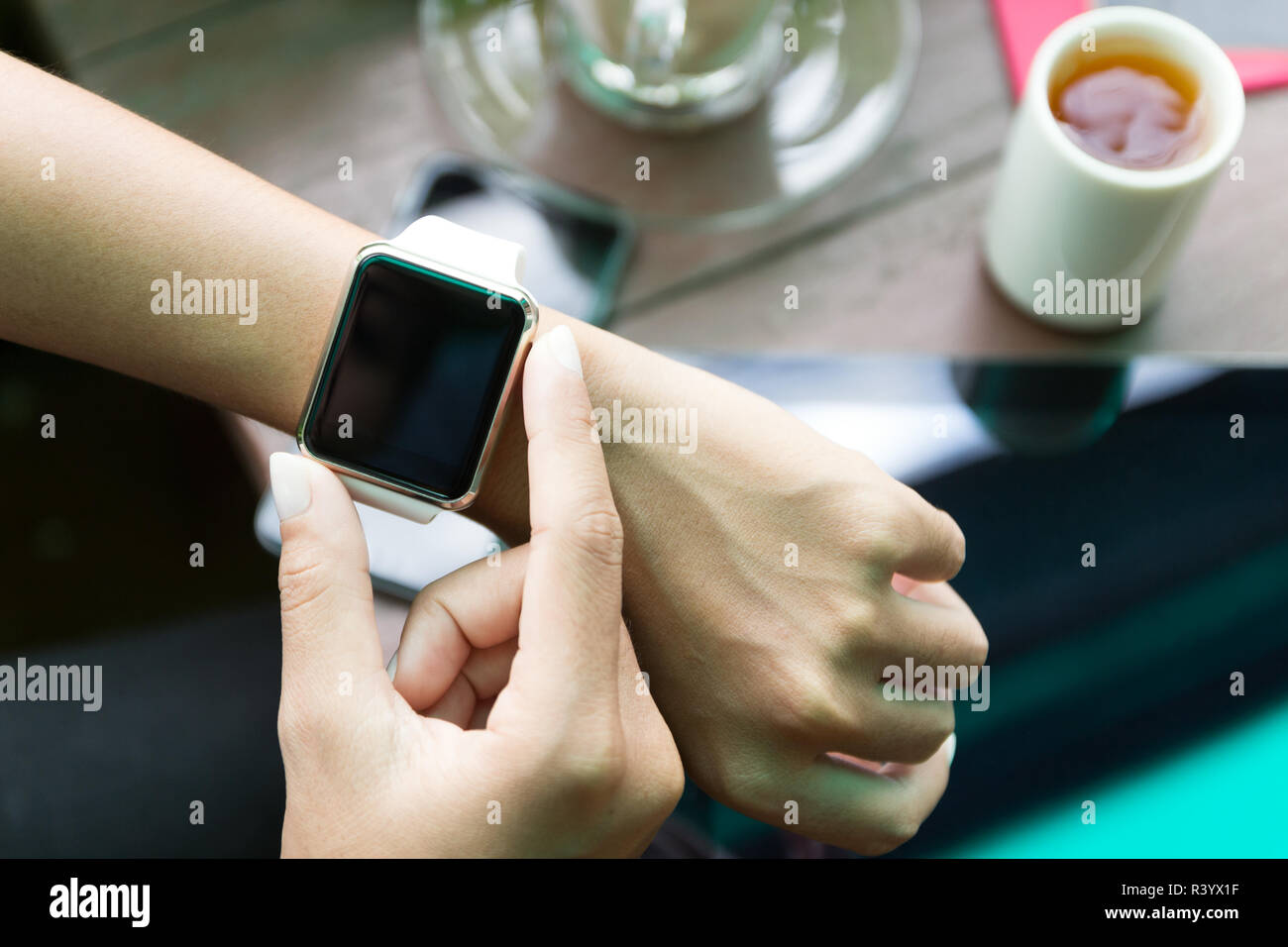 hand using watch on top view Stock Photo - Alamy