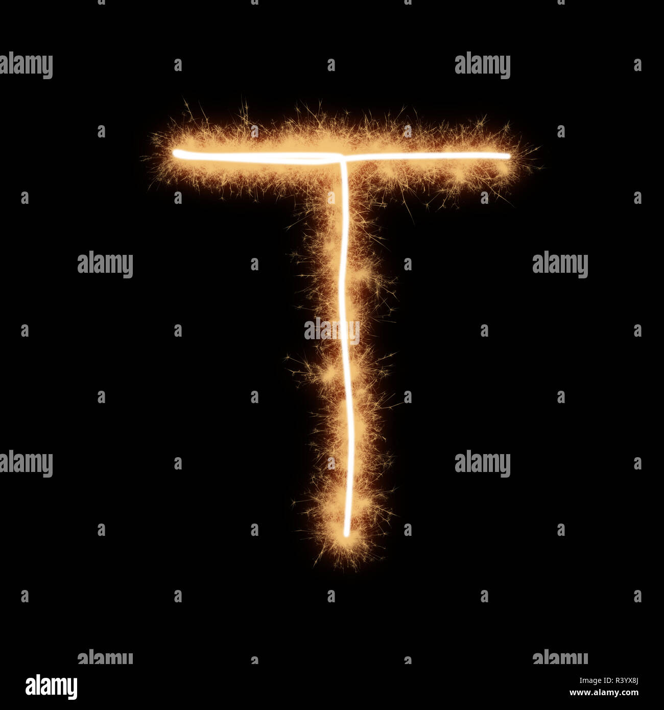 Letter T of alphabet written by squib sparks on a black background ...