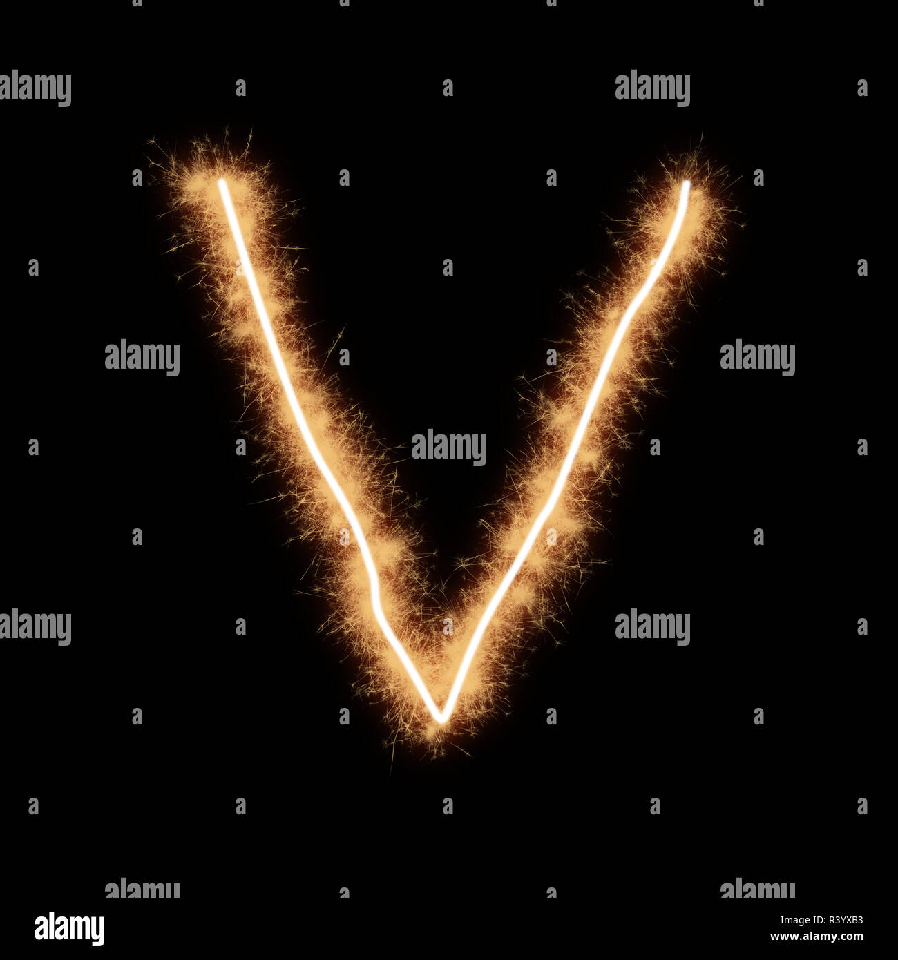 Letter V of alphabet written by squib sparks on a black background ...