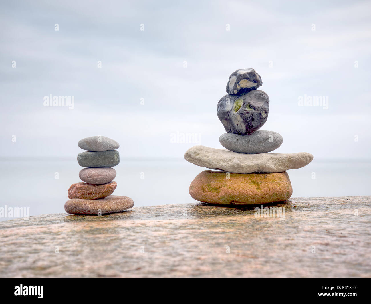 Stack of rounded stones on the sea beach. Pyramid of zen stones on ...