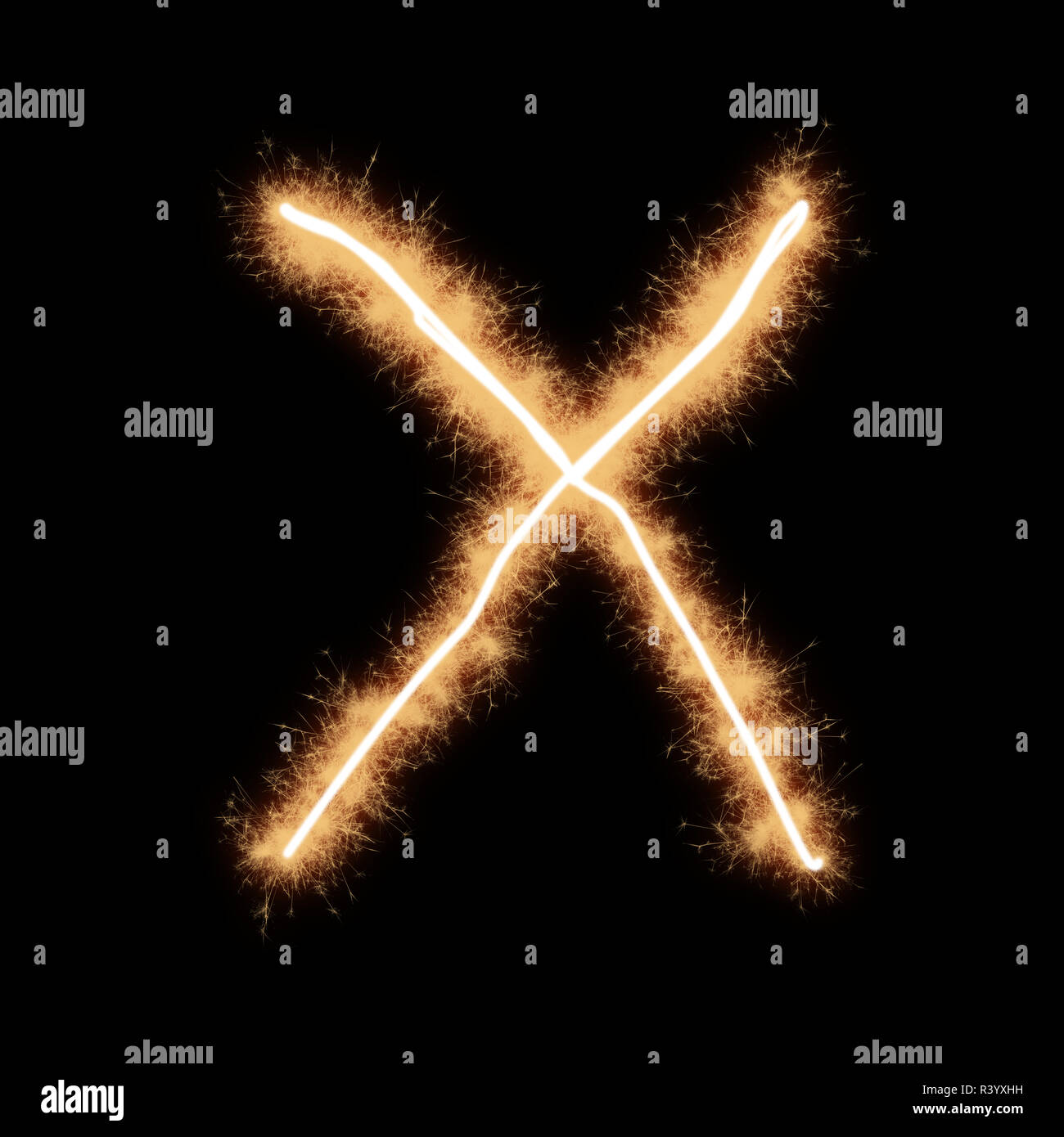 Letter X of alphabet written by squib sparks on a black background ...