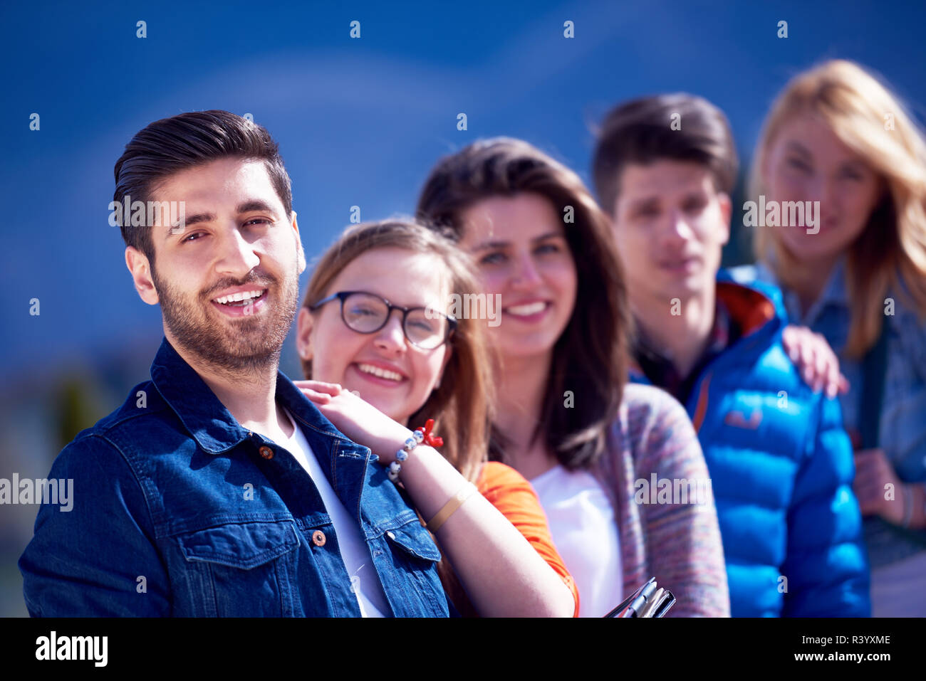 Happy team of students jumping hi-res stock photography and images - Alamy