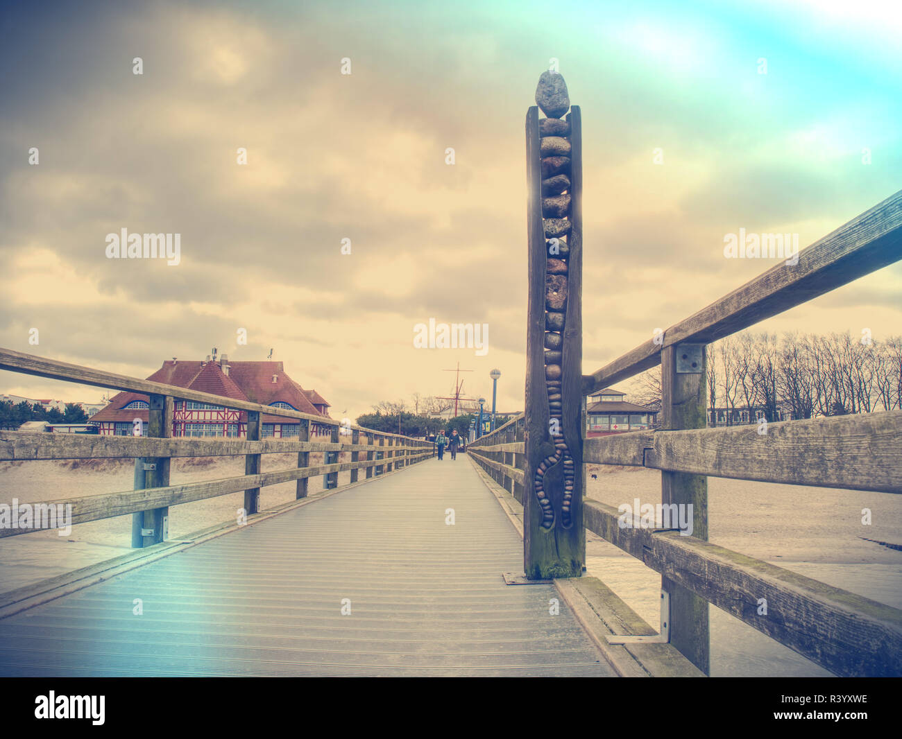Wooden batten bridge juts out into the expanse of the sea.. Hipster ...