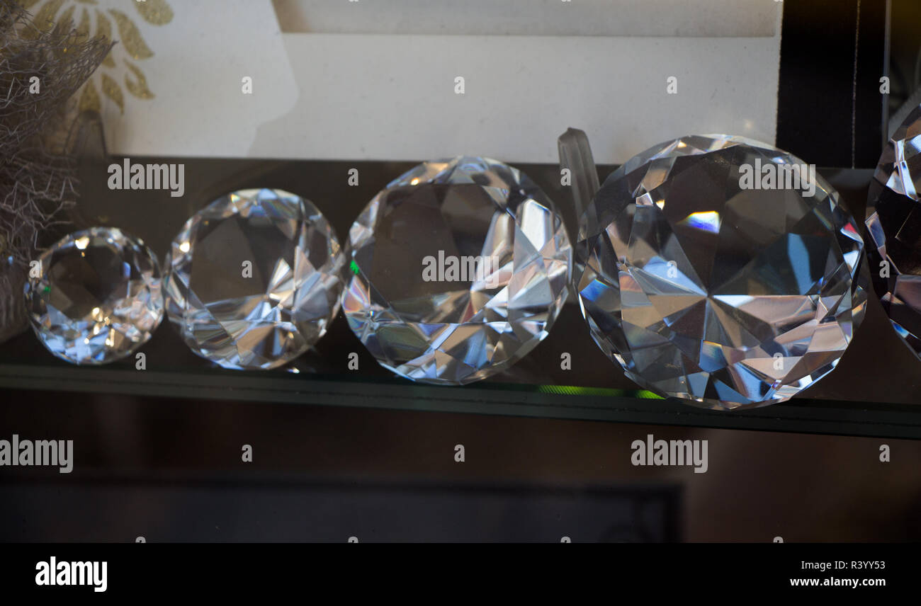 Five transparent diamonds aligned from small to big on display Stock ...