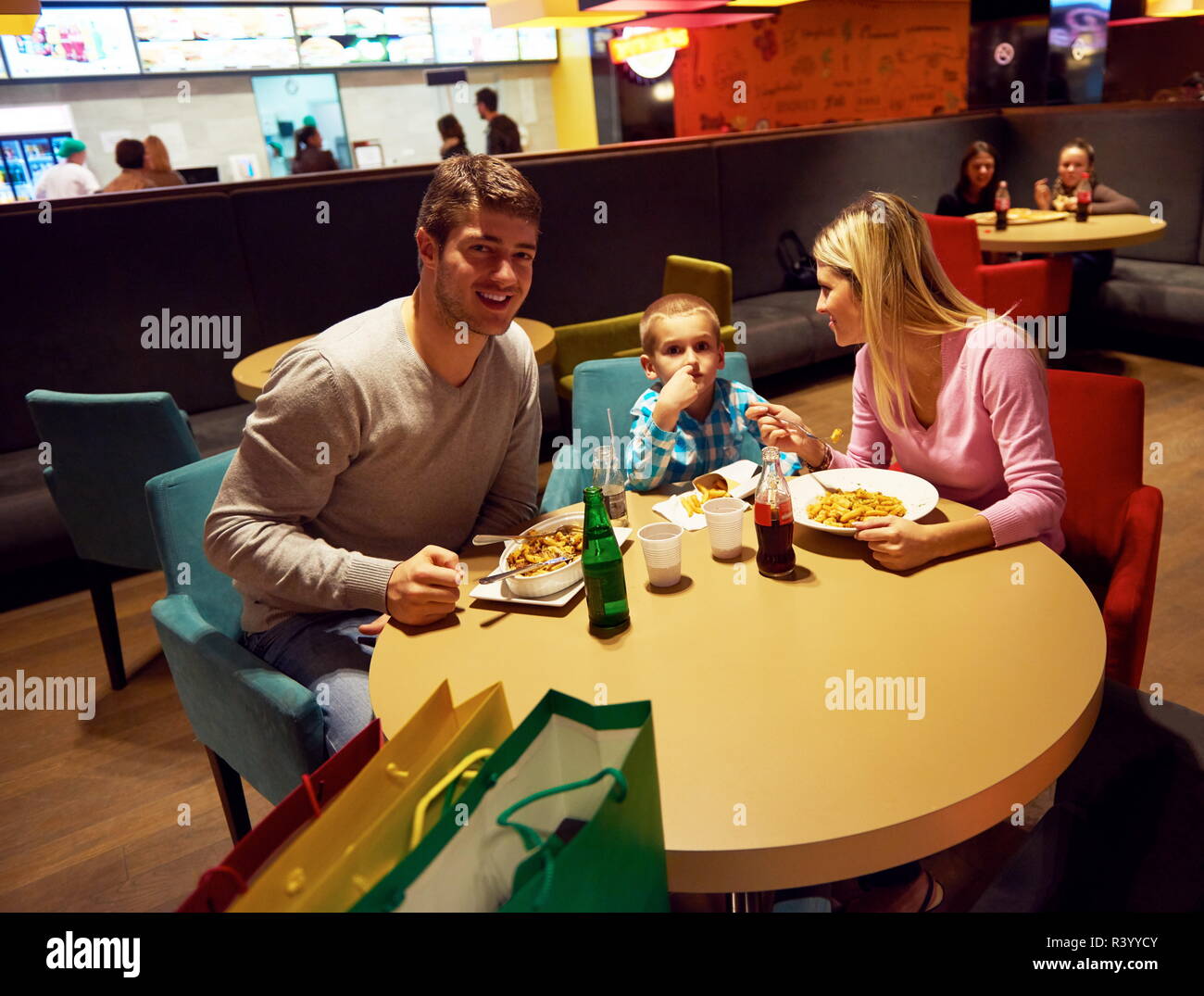 family having lunch in shopping mall Stock Photo - Alamy