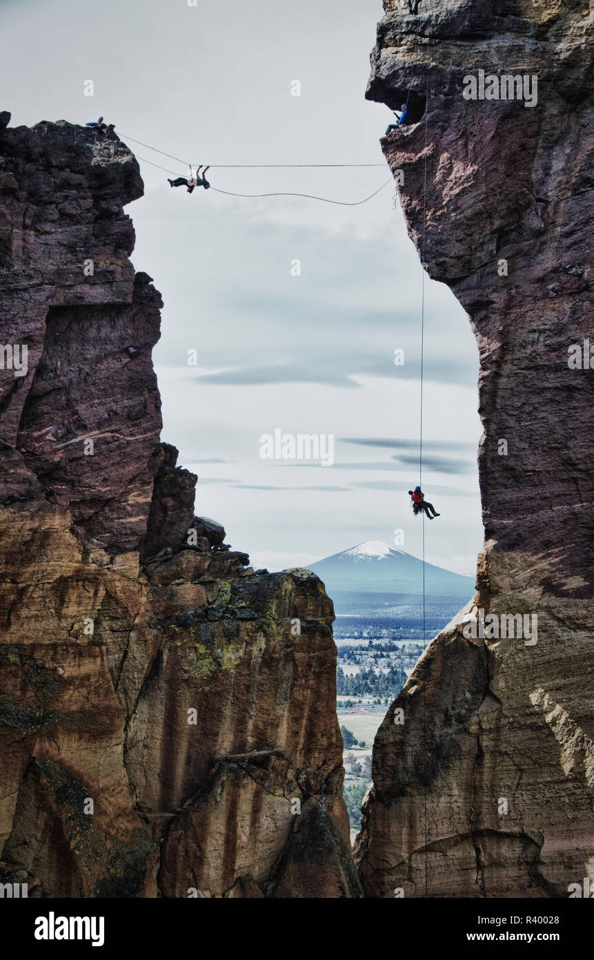 USA, Oregon, Smith Rock State Park, Rock Climbers explore Monkey Face ...