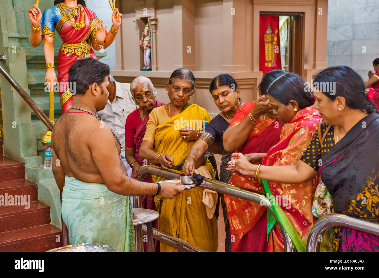 The priest stands in front of the garbagraham when performing the puja ...