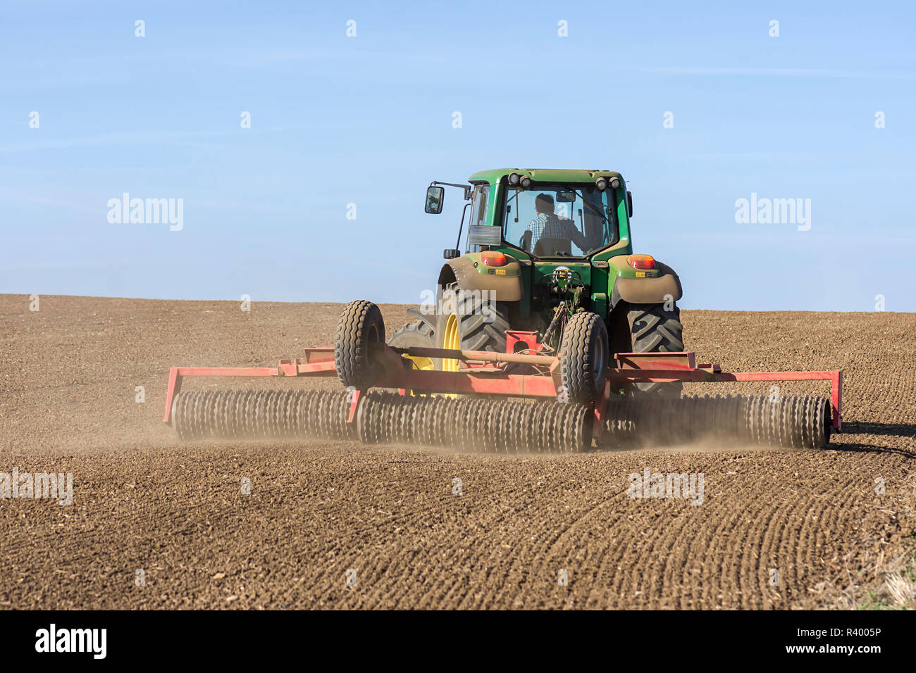 Farmer harrowing his harvested field, Franconia, Bavaria, Germany Stock ...