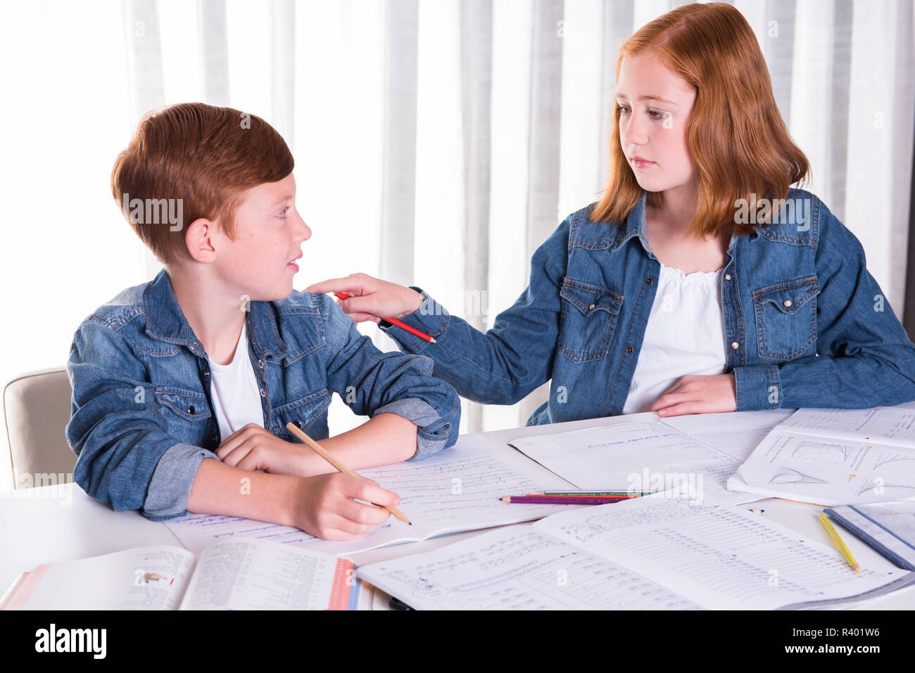 sister is helping brother with homework Stock Photo - Alamy