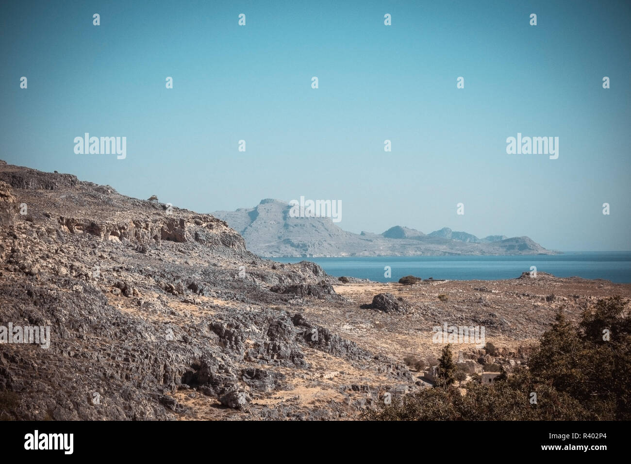 Horizontal photo with dry rocks covered just by stones. Rocks are brown ...