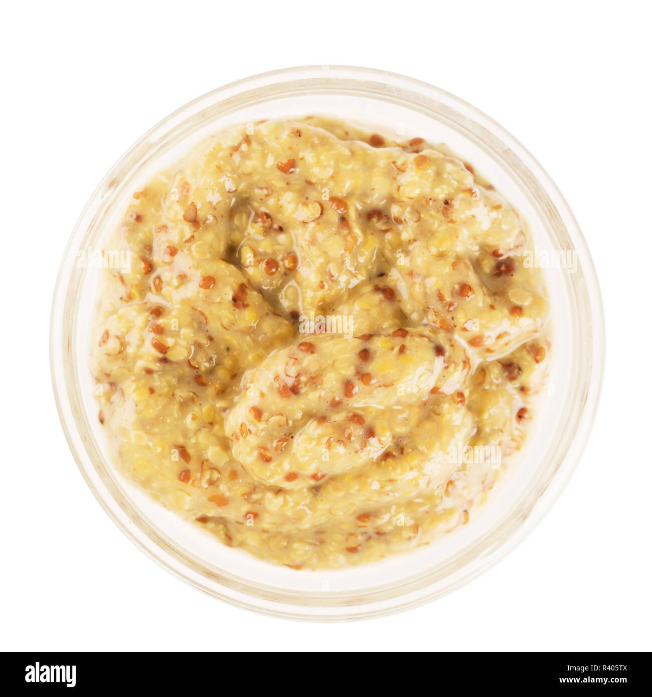 Stone ground mustard in a glass bowl, isolated on white and viewed from ...