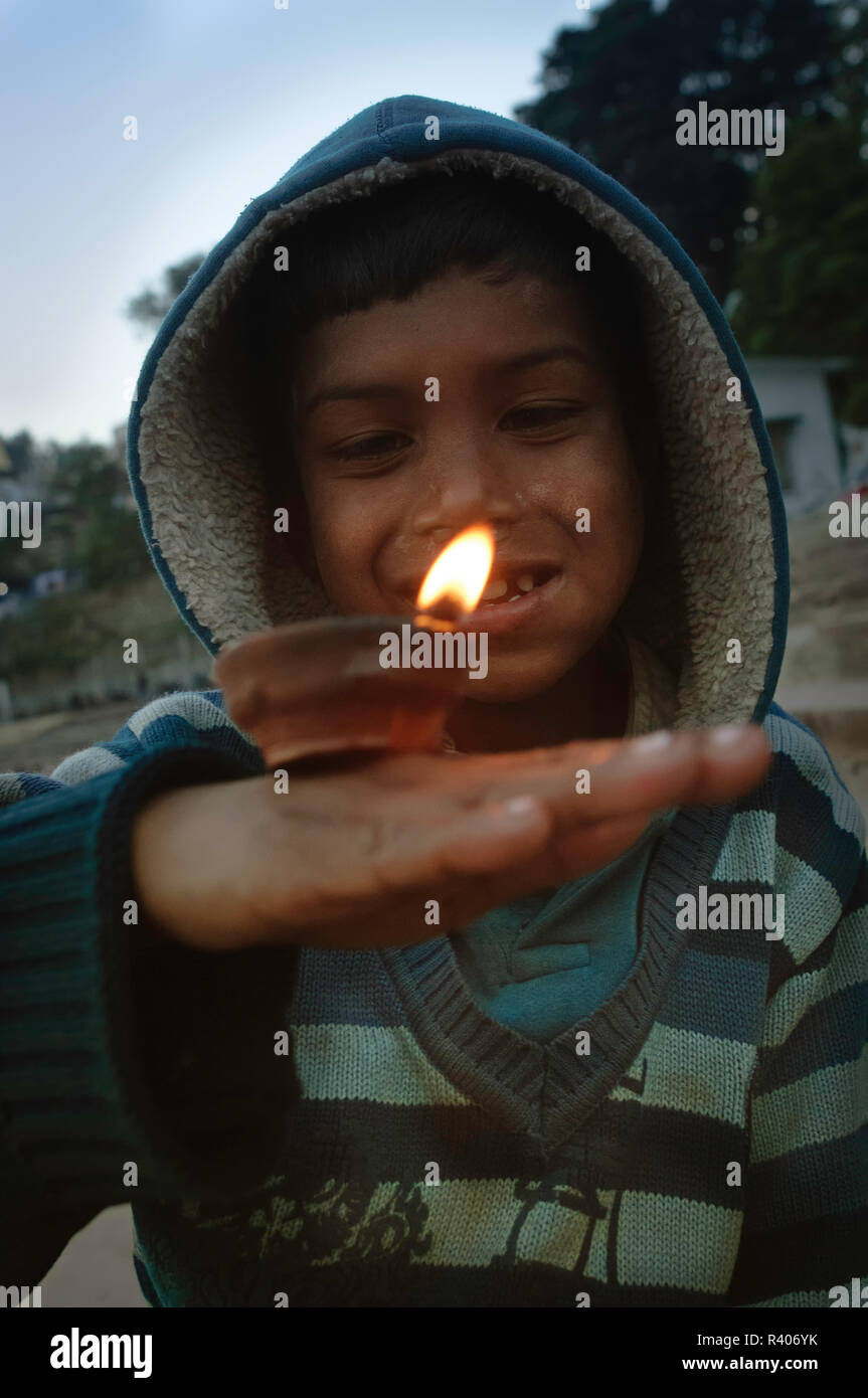 Boy playing with offer candle. Rishikesh, India Stock Photo - Alamy