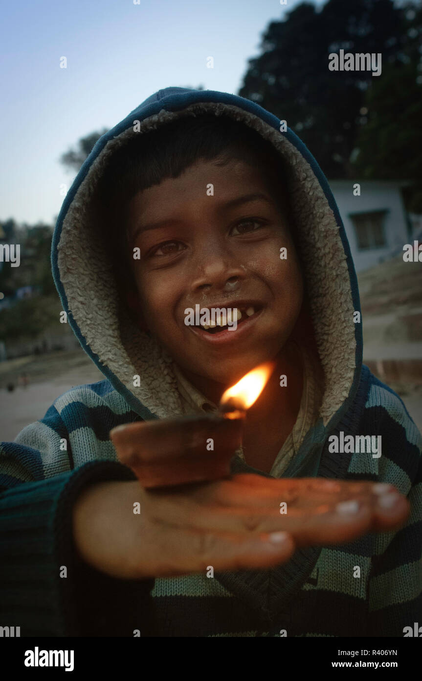 Boy playing with offer candle. Rishikesh, India Stock Photo - Alamy