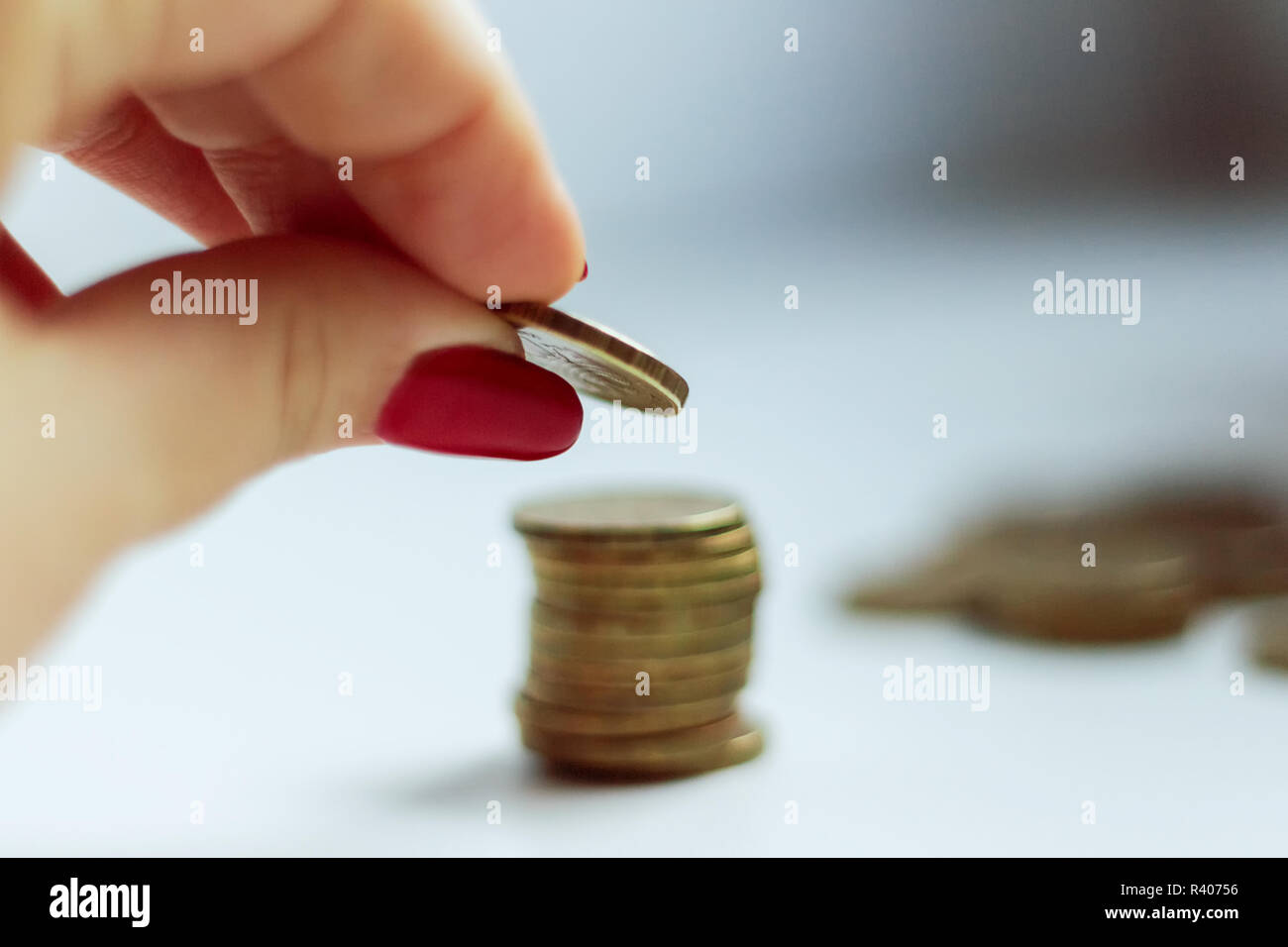 folding a tower of accumulated gold coins close-up Stock Photo - Alamy