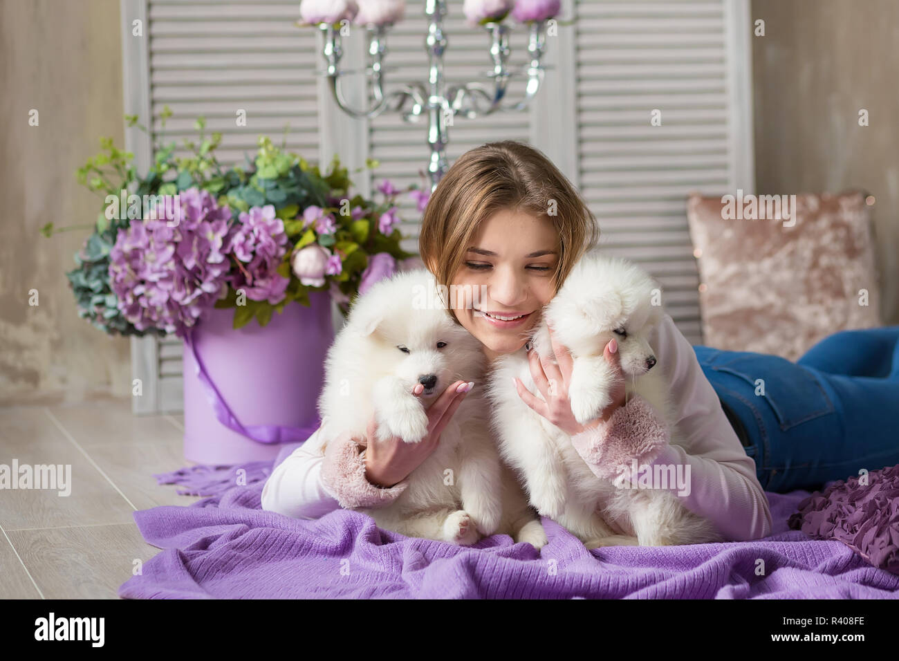 Portrait of blond lady girl playing with husky poppy.Model girl with ...