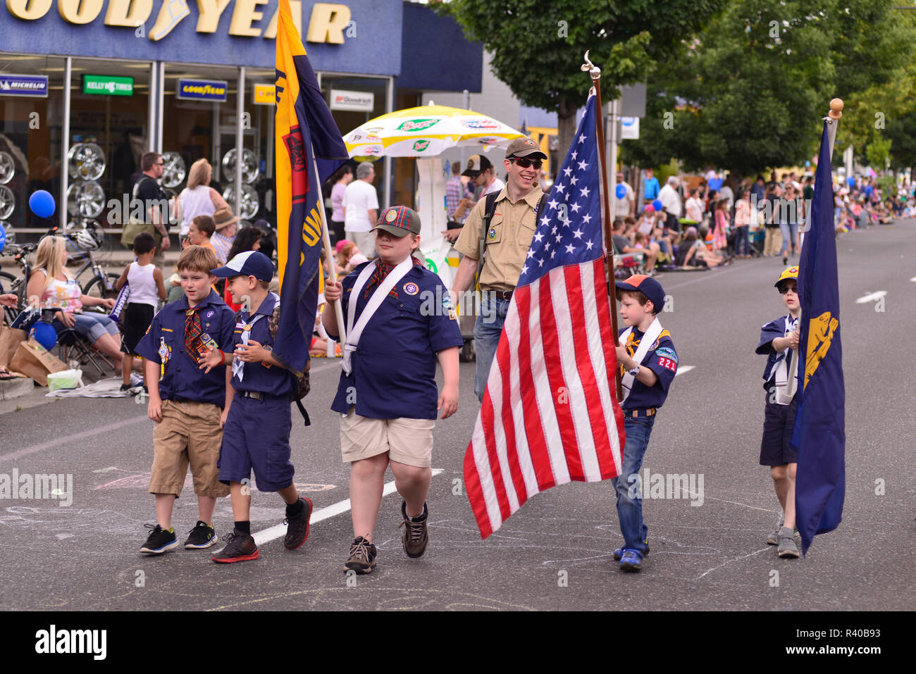 USA, Oregon, Portland. Cub Scouts march with flags in parade. Credit as ...