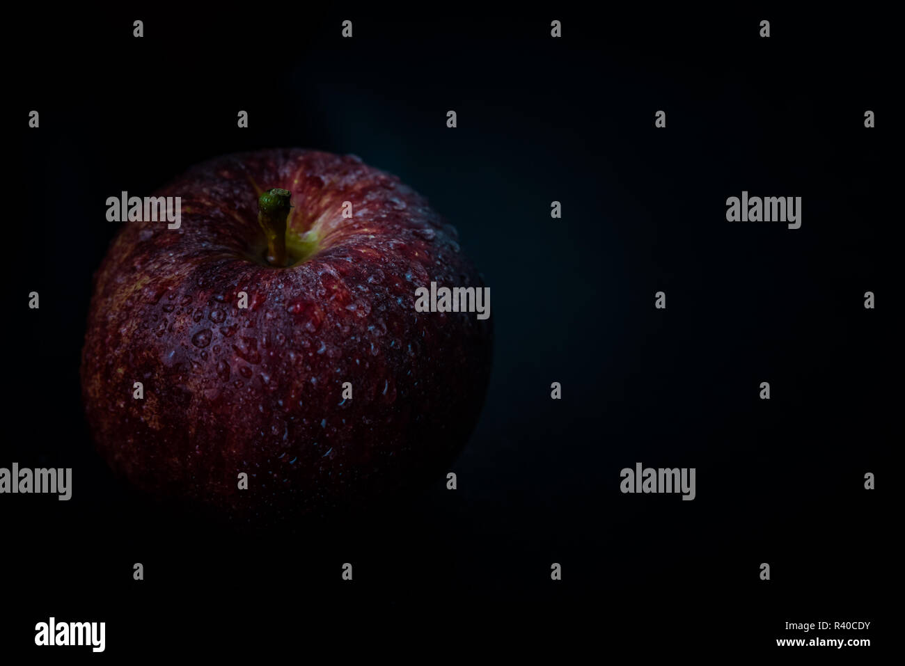 Close up of red apple against black background Stock Photo - Alamy