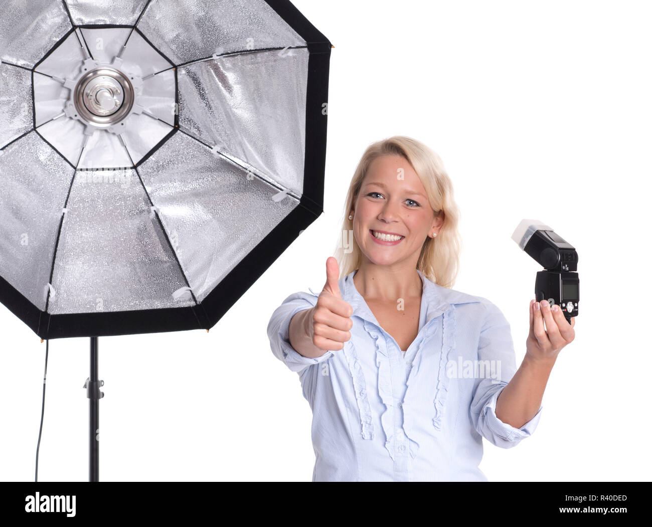 photographer with studio flash and compact flash showing thumbs up ...