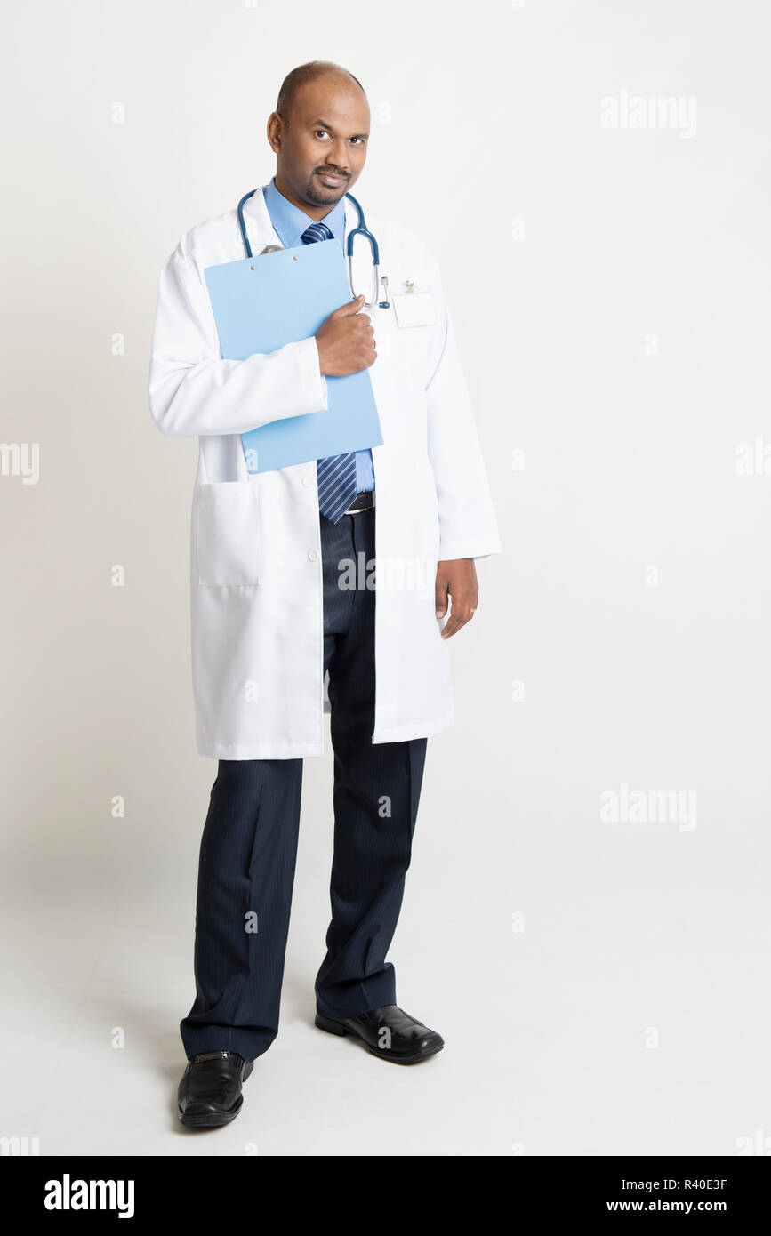 Mature Indian doctor holding medical report Stock Photo - Alamy