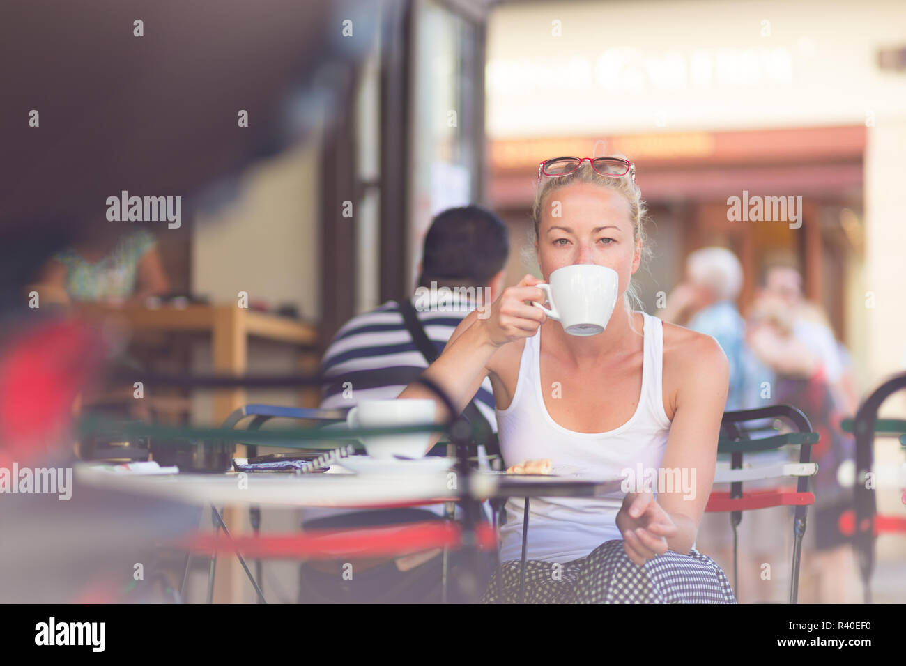 Woman drinking coffee outdoor on street Stock Photo - Alamy