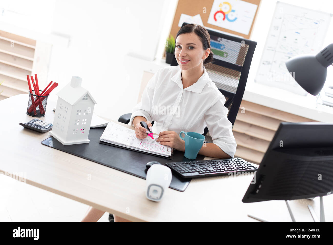 A young girl working in the office at the computer Stock Photo - Alamy
