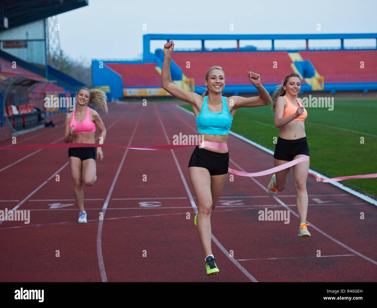 Female Runners Finishing Race Together Stock Photo - Alamy