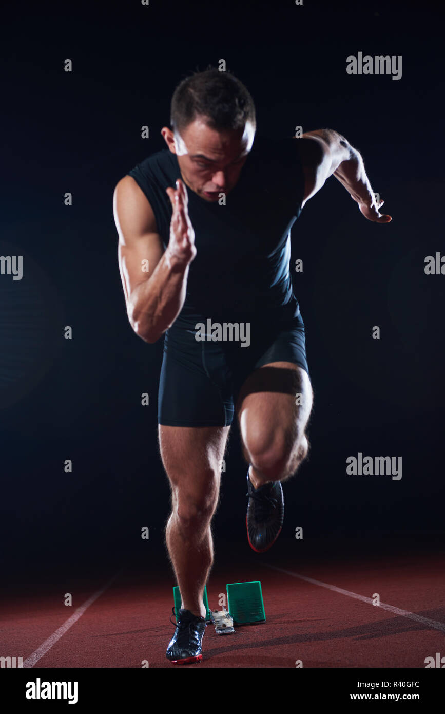 Sprinter leaving starting blocks Stock Photo - Alamy