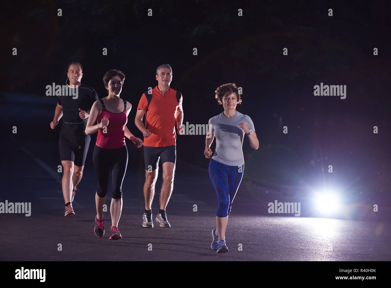people group jogging at night Stock Photo - Alamy