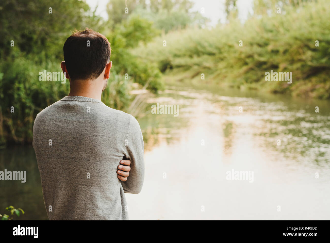 Young man posing in nature with trees, calm Stock Photo - Alamy