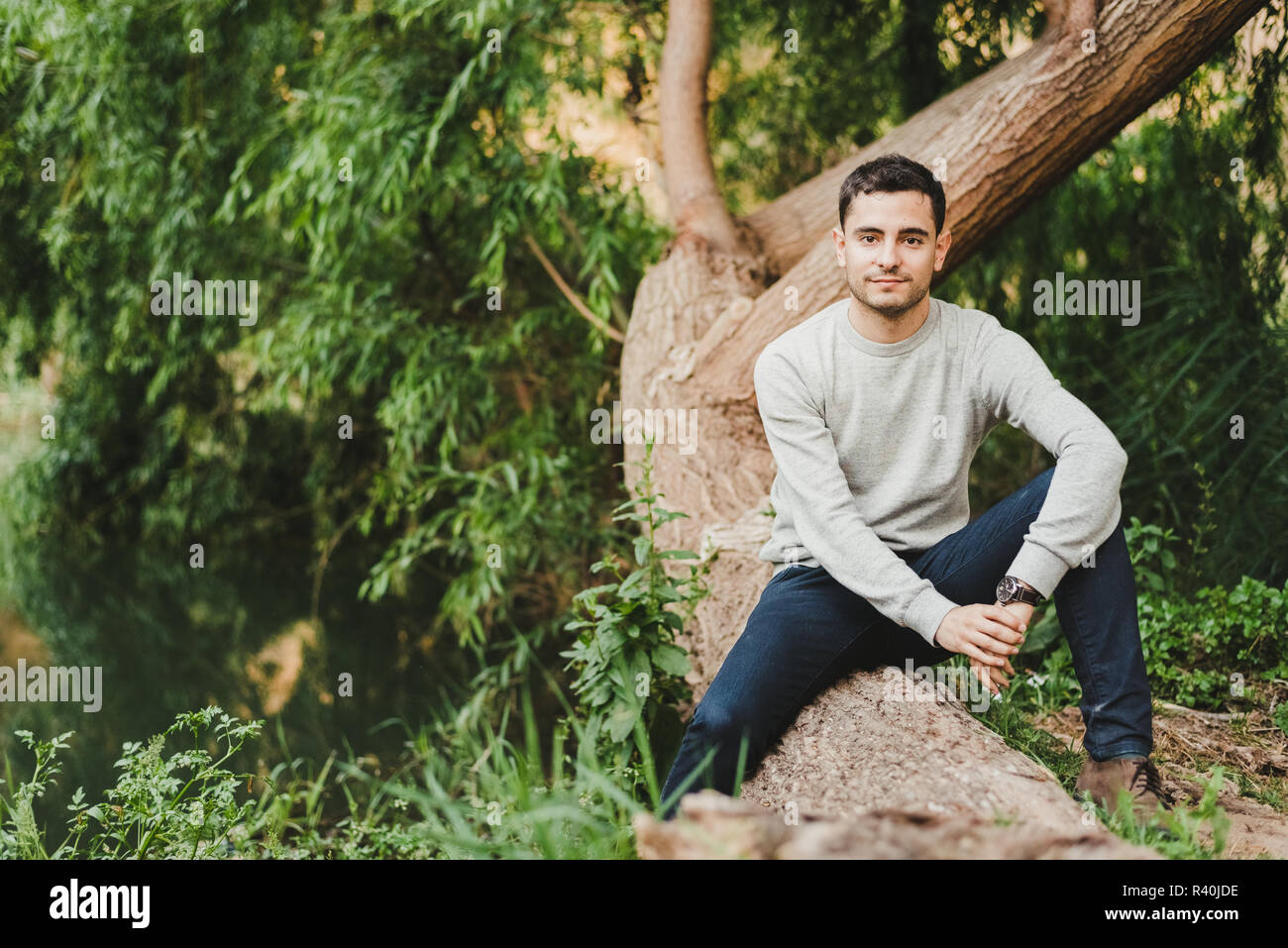 Young man posing in nature with trees, calm Stock Photo - Alamy
