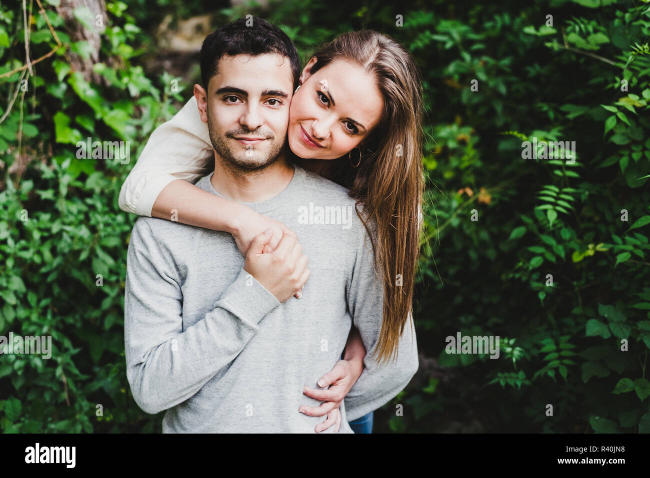 Couple in love hugging each other with their hands Stock Photo - Alamy