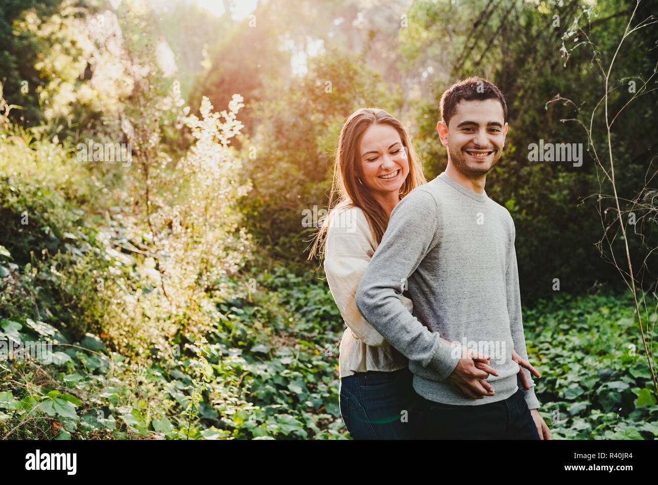 Enamored couple hugging laughing hi-res stock photography and images ...