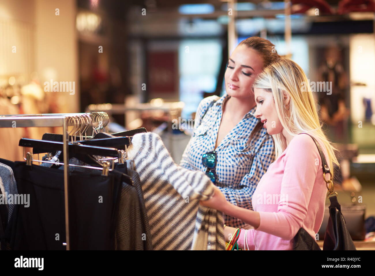 happy young girls in shopping mall Stock Photo - Alamy